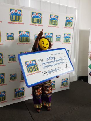 Jamaican lottery winner shows up in a mask to claim her $180 Million prize